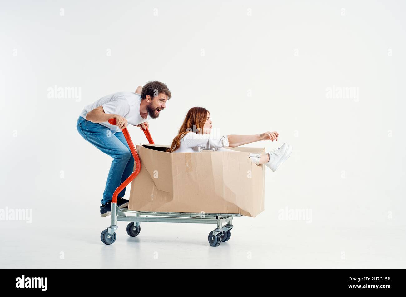 a young couple ride a cart entertainment isolated background Stock ...