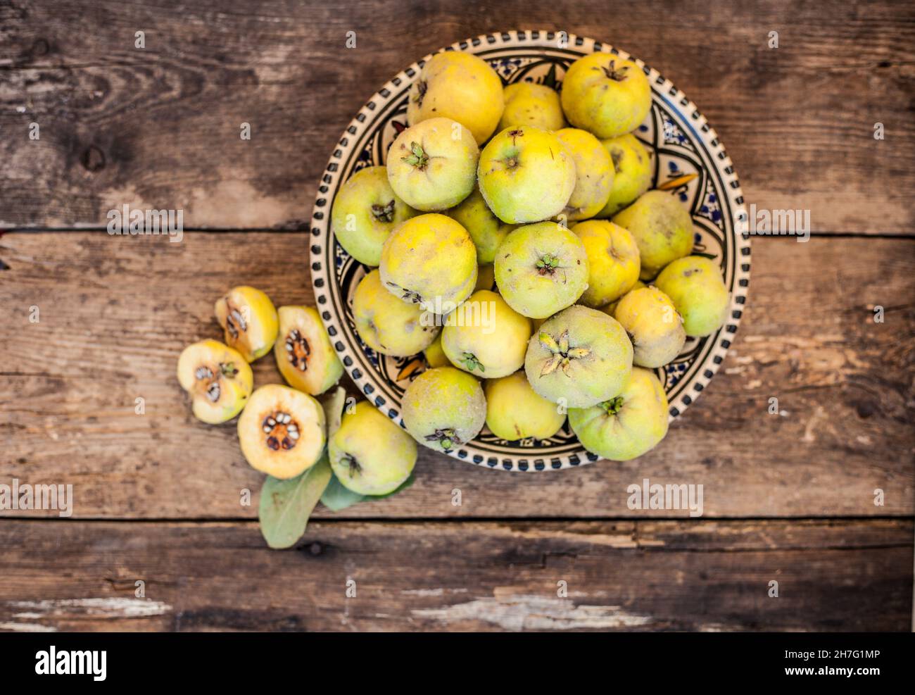 Quince fruits on a wooden background. Harvest of autumn fruits. Yellow ...