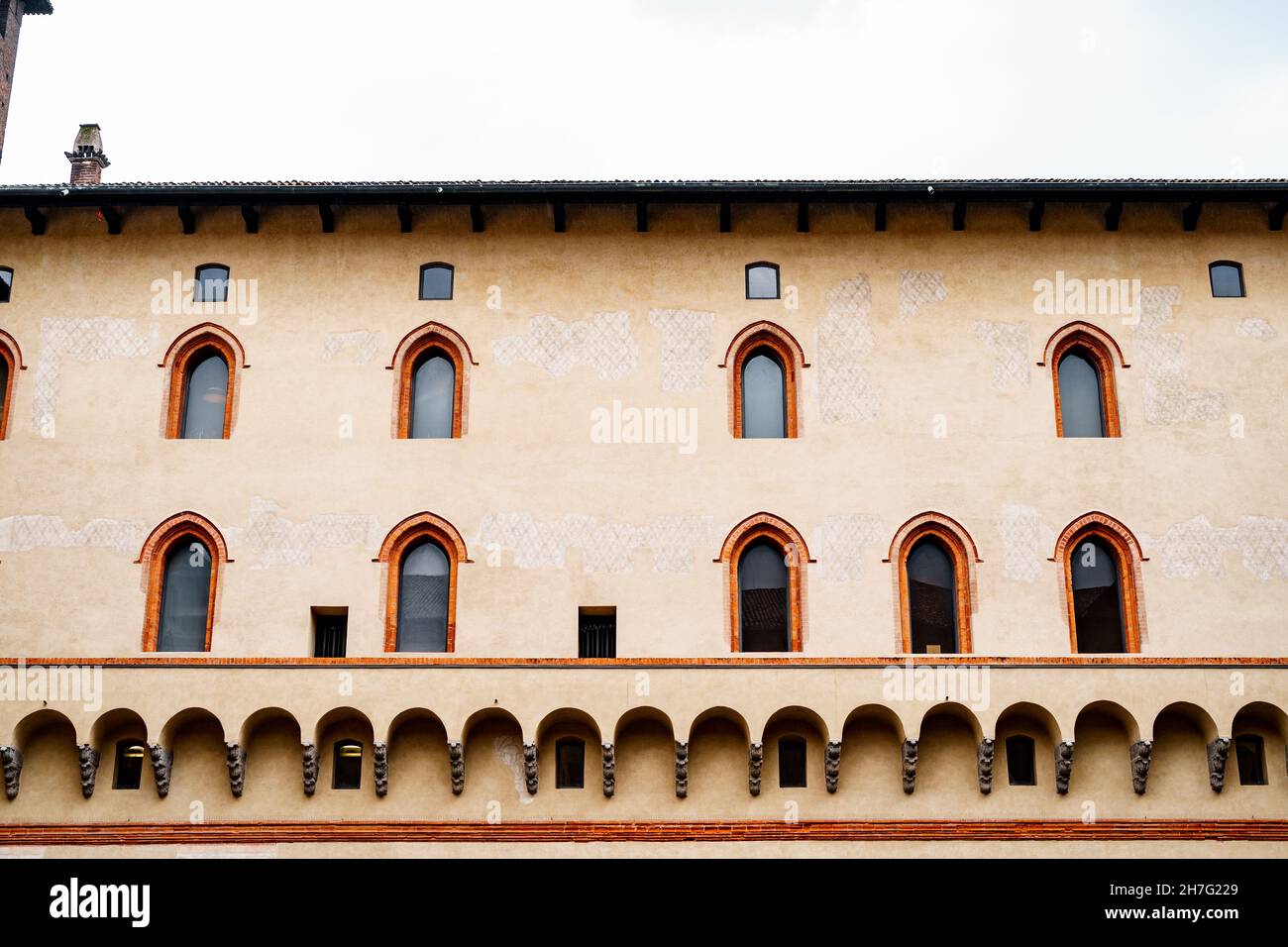 Arched windows and molding on the Castello Sforzesco wall. Milan, Italy ...