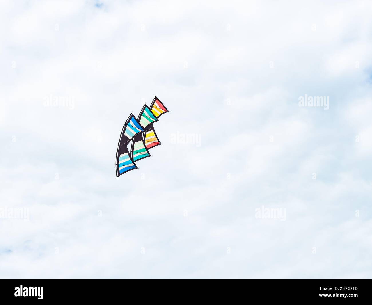 Stack of three quad line stunt kites against white clouds Stock Photo ...