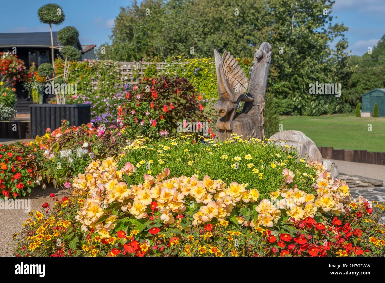 Beautiful flower tubs and baskets in a garden Stock Photo - Alamy