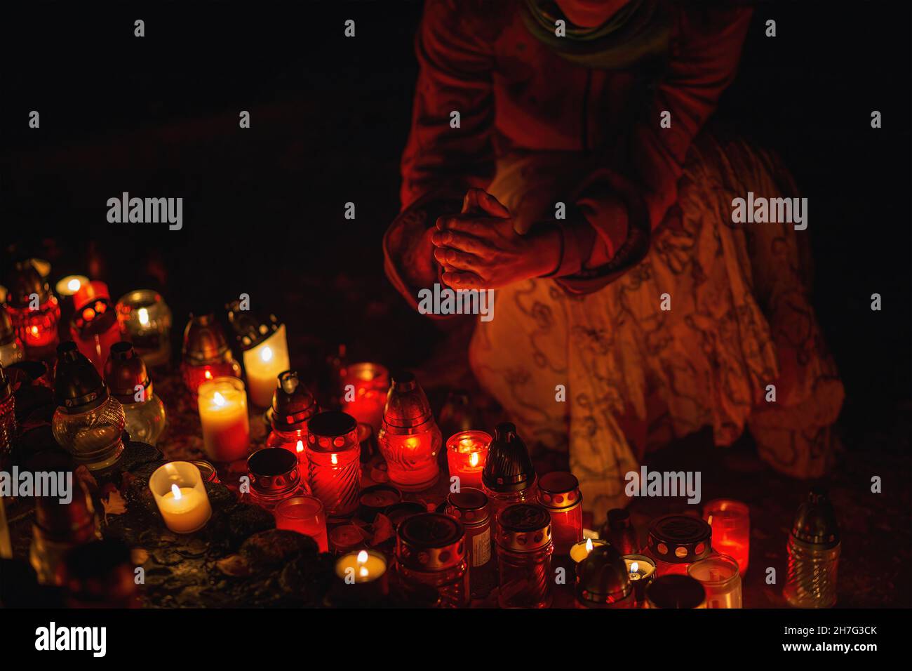 prayer woman. Candles in the cemetery. 1st November. Feast of All ...