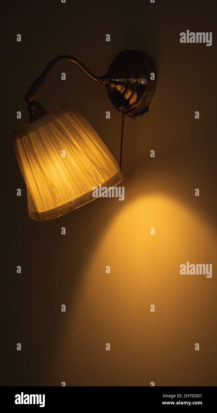 Lamp lit in the living room of the house illuminating the wall Stock ...