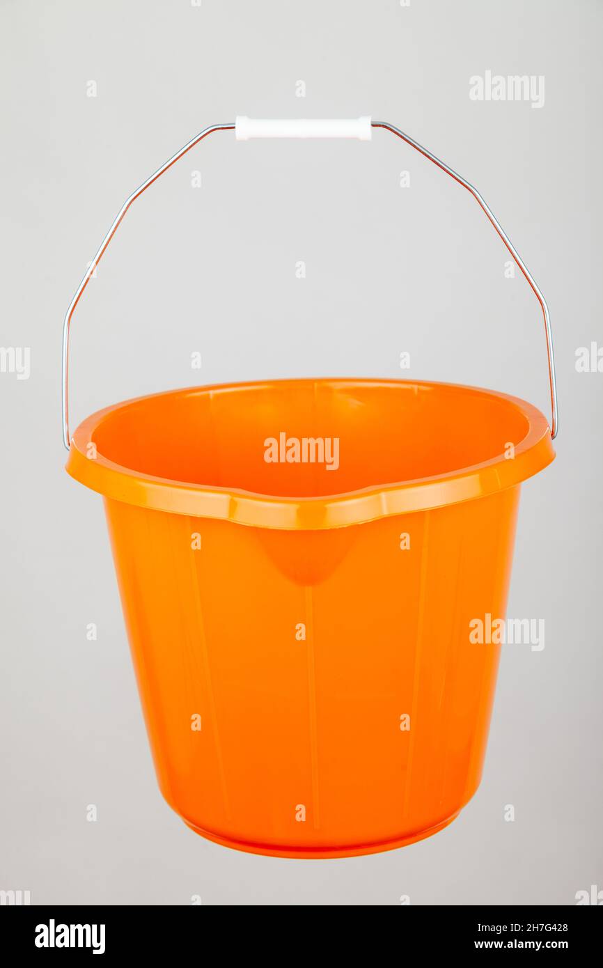 Orange plastic bucket on white background Stock Photo - Alamy