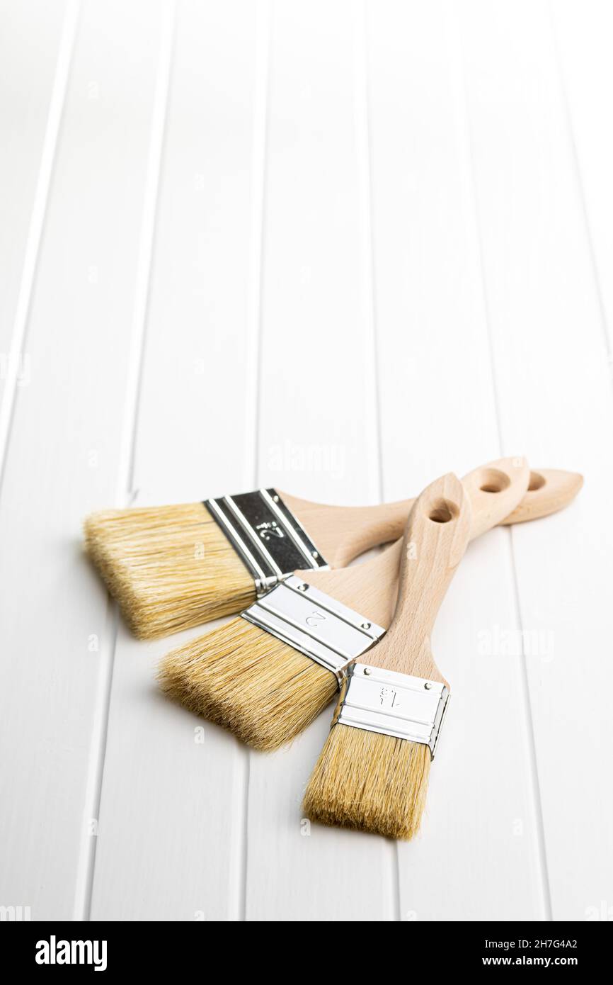 Set of clean paint brushes on white table Stock Photo - Alamy