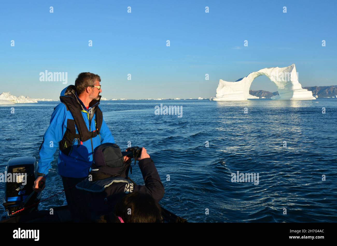 DENMARK. GREENLAND. WEST COAST. ZODIAC WITH TOURISTS IN FRONT OF AN ...