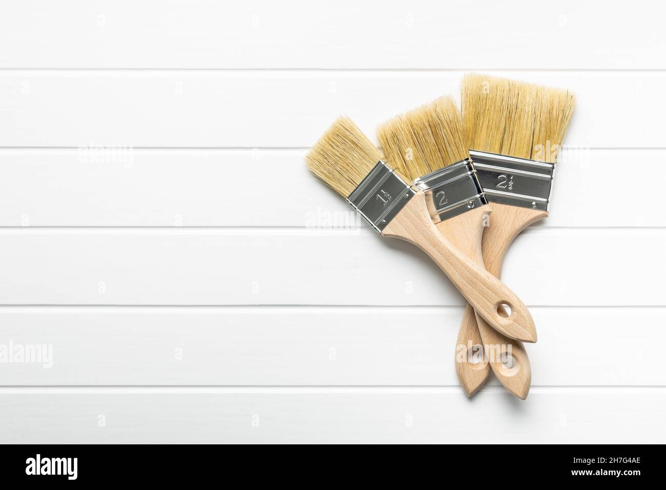 Set of clean paint brushes on white table Stock Photo - Alamy