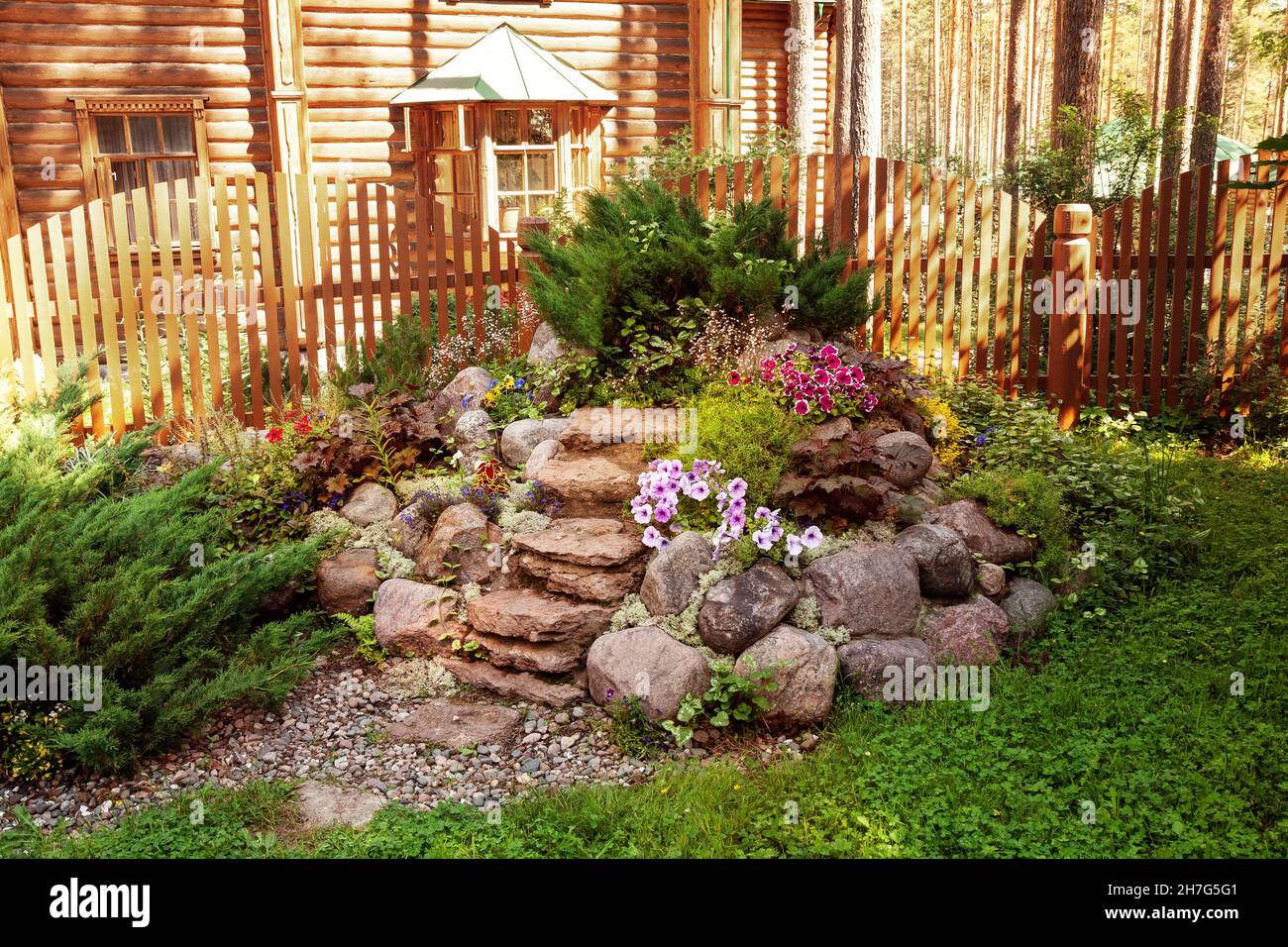 Rock garden made of large stones of different types of flowers Stock ...