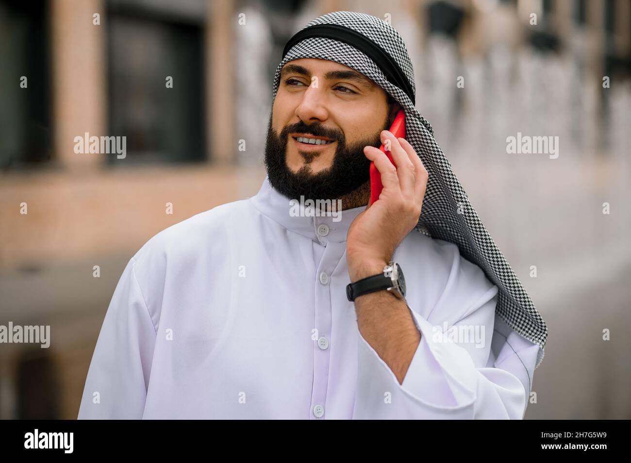 Arabian man with a smartphone in hands Stock Photo - Alamy