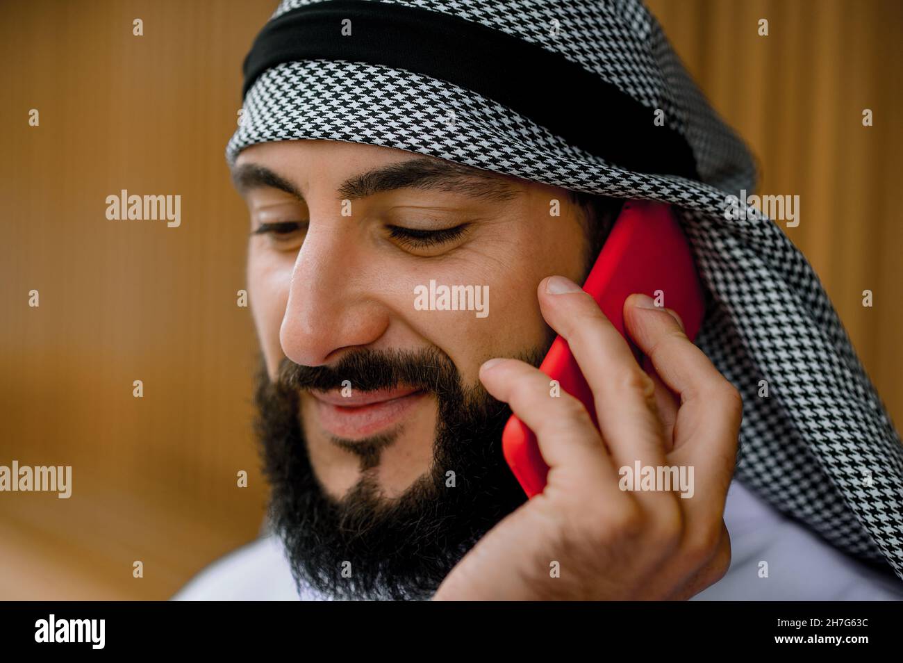 Middle eastern young man talking on the phone Stock Photo - Alamy