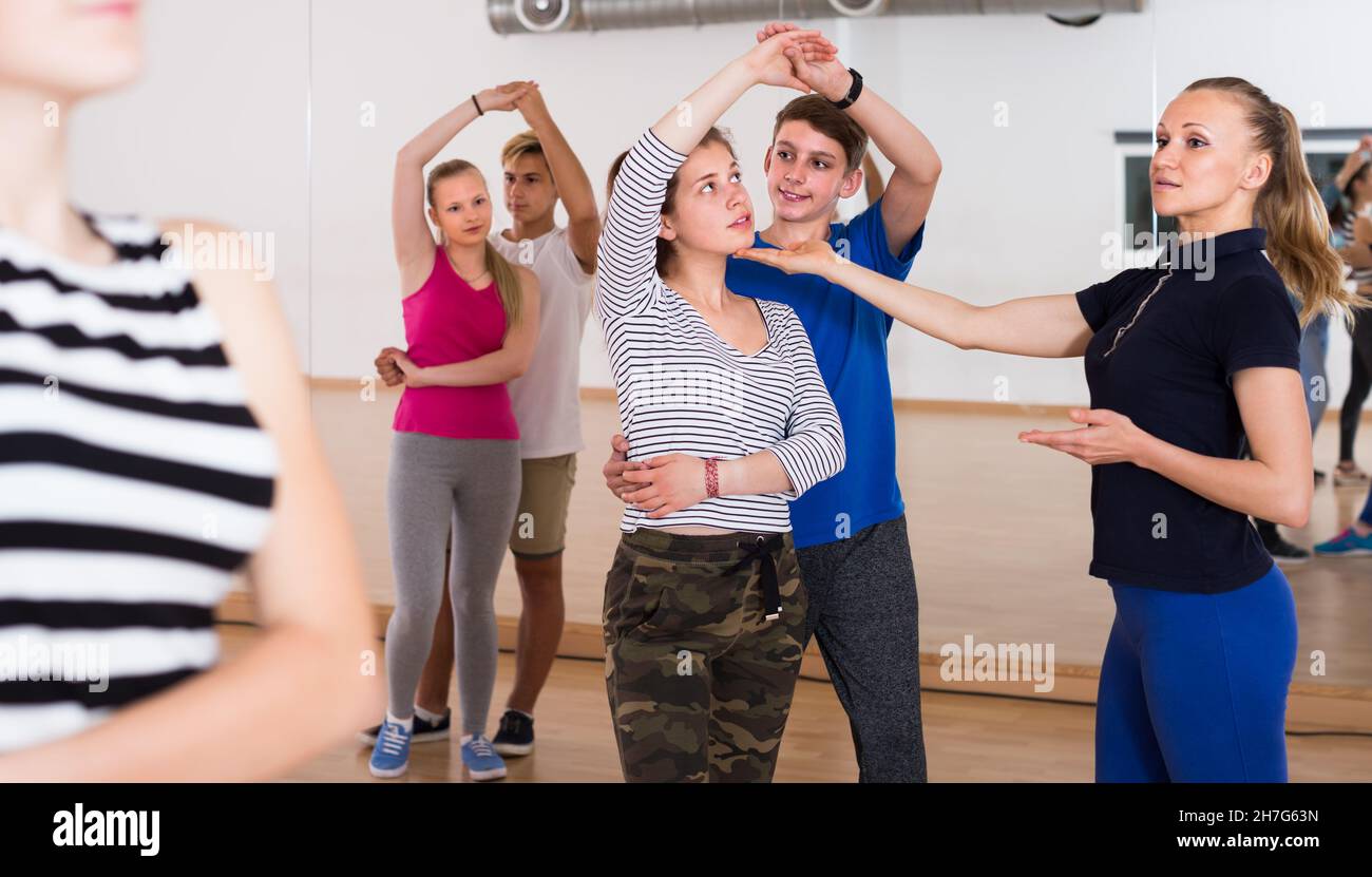 Group of friendly teenagers dancing tango in dance studio Stock Photo ...
