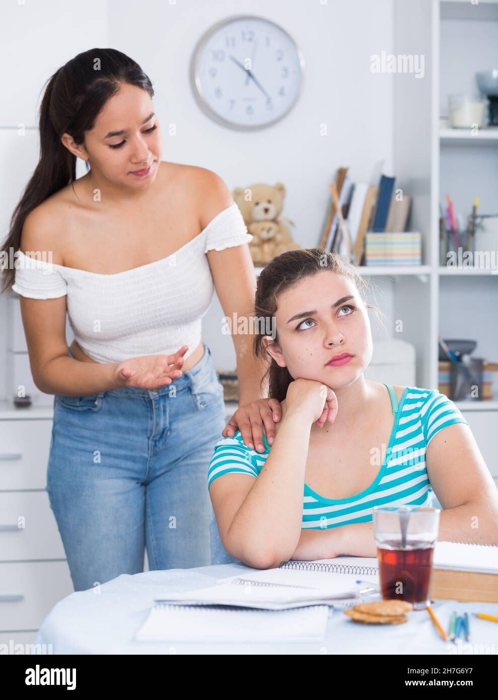 Two teenage girls squabbling at home Stock Photo - Alamy