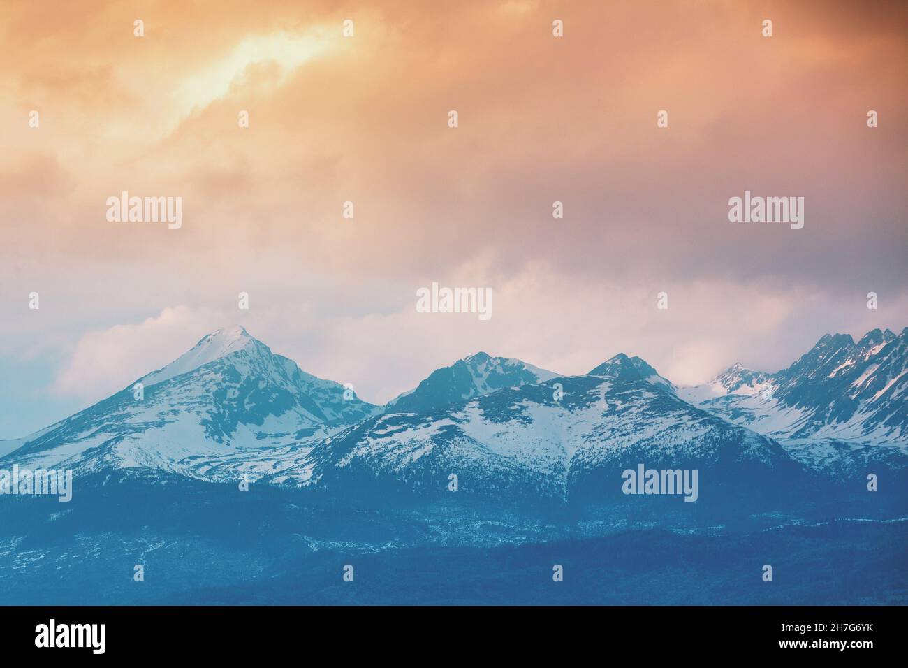 Beautiful snow-capped mountains against the backdrop of a sunset sky ...