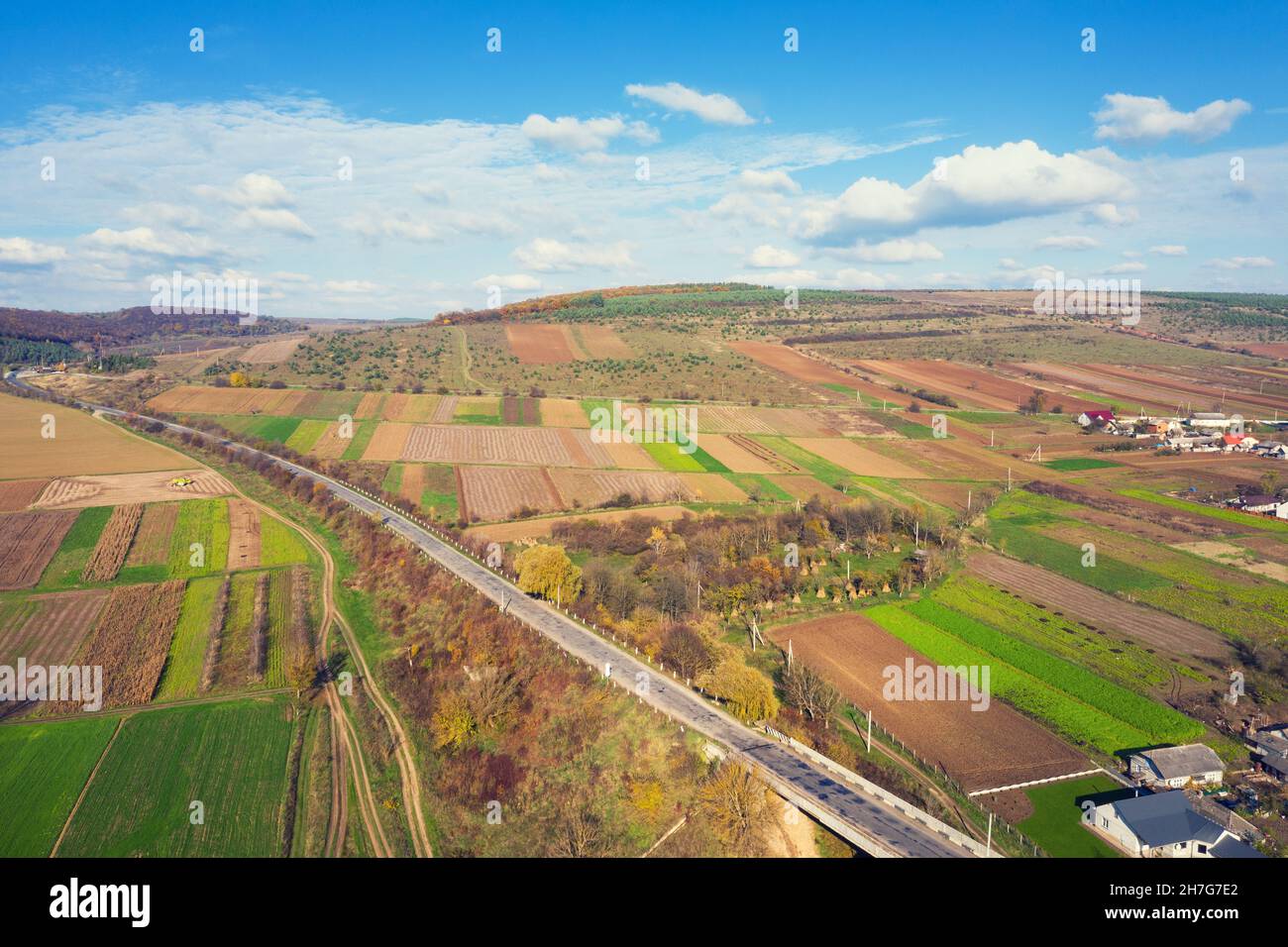 Aerial view of the countryside. Highway and farmlands near the village ...