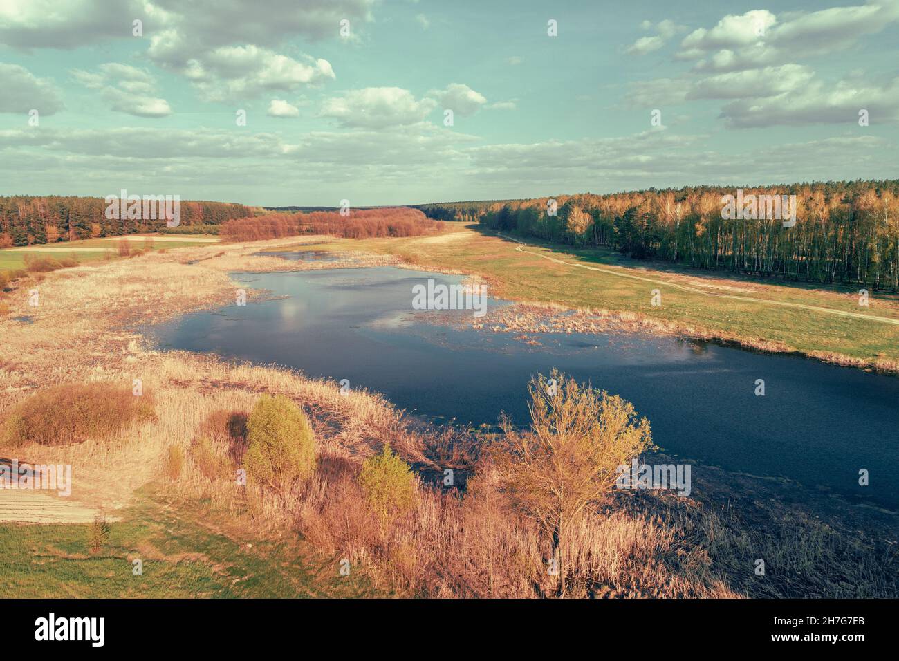 Aerial view of countryside and winding brook in the evening at sunset ...