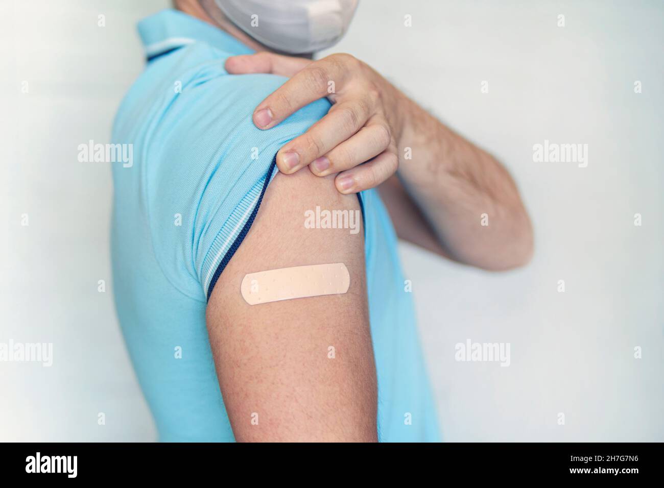 Brown adhesive bandage on young man's arm after scratch on skin or ...
