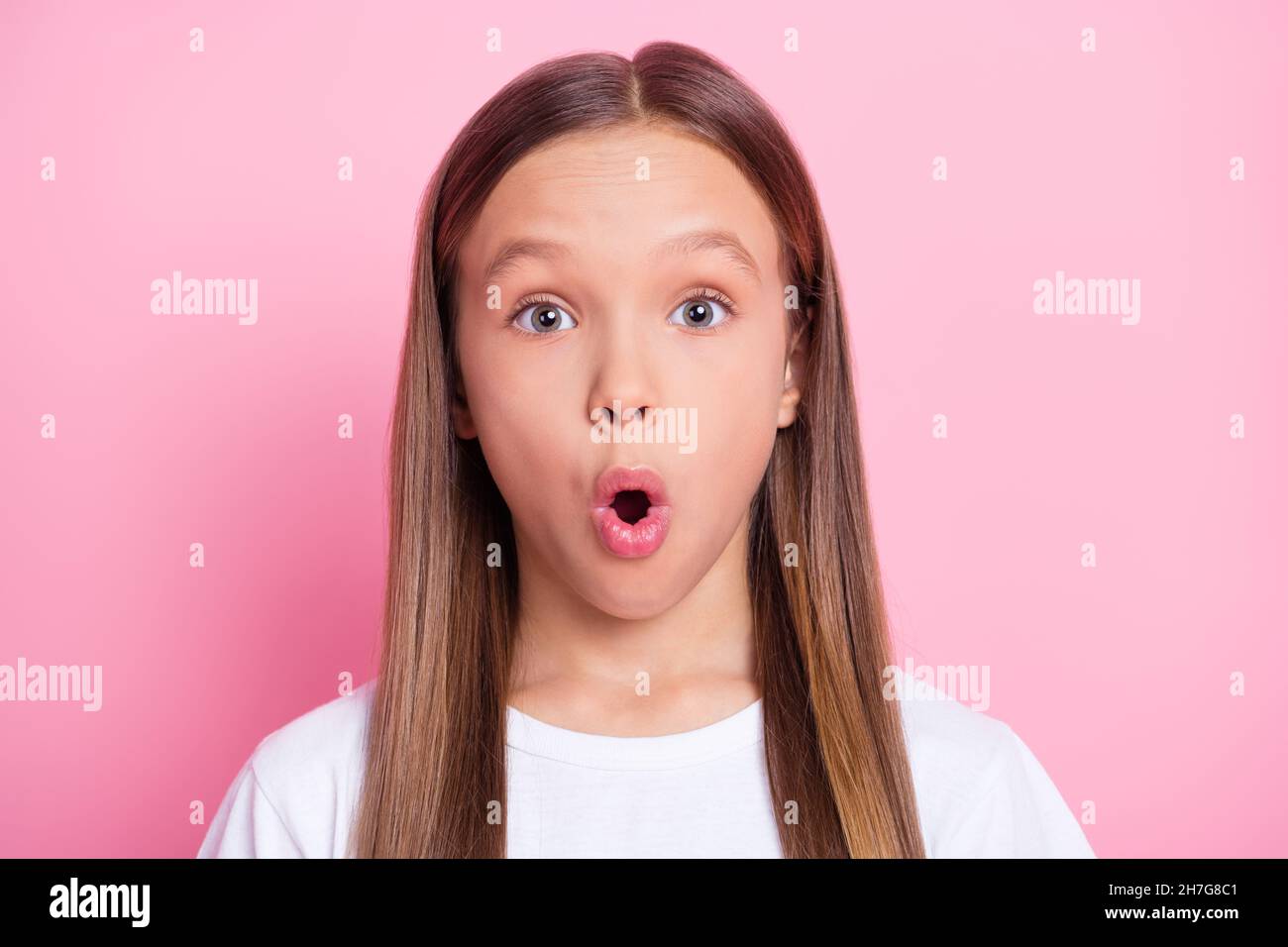Portrait of young lovely shocked amazed surprised little girl see huge ...