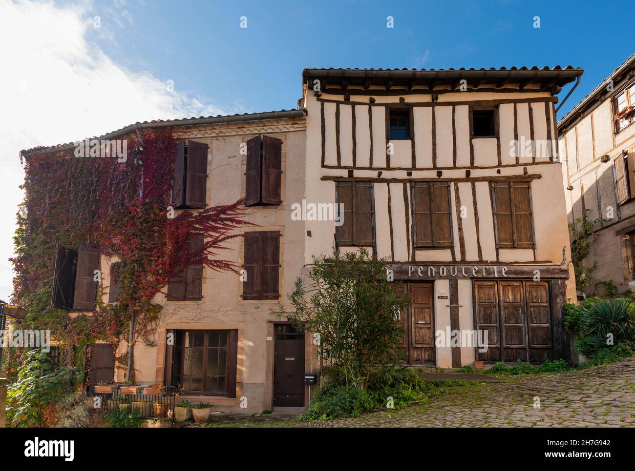 Old street and house facade in the medieval village of Cordes sur Ciel ...