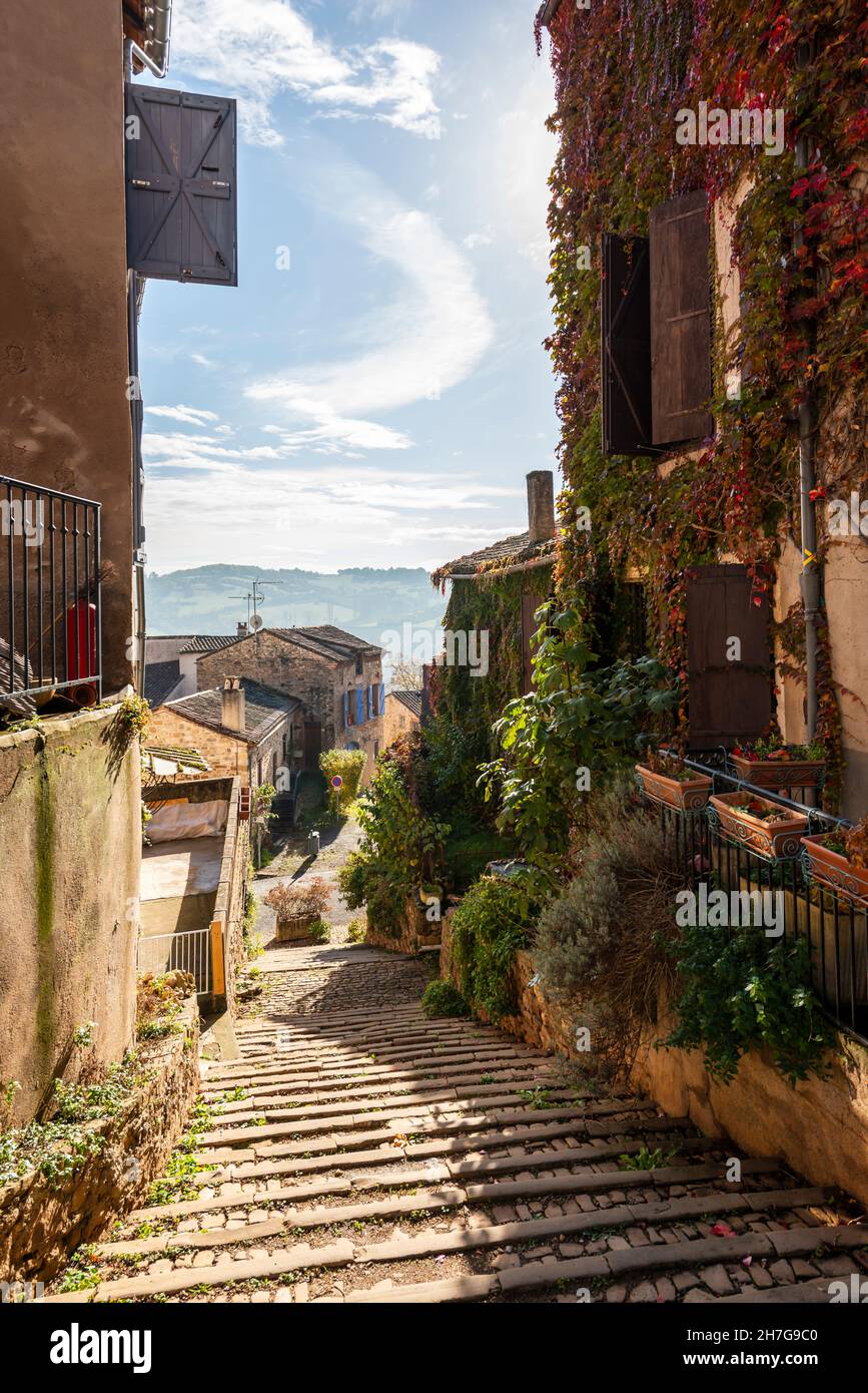 Old street and house facade in the medieval village of Cordes sur Ciel ...