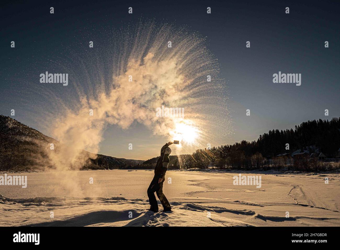 MOSJOEN, NORWAY - Feb 07, 2021: A person throwing warm water in the ...