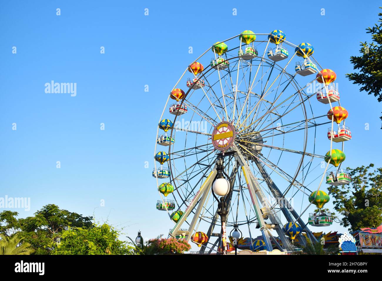 Beautiful view of the colorful Ferris wheel on a bright and sunny day ...