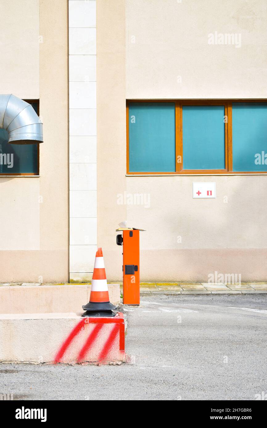 Road signal cone and a barrier in front of a building Stock Photo - Alamy