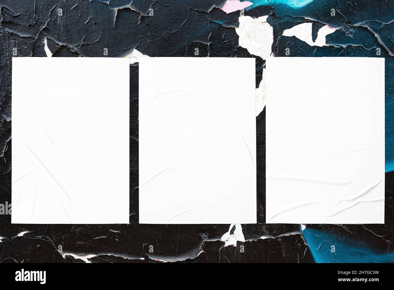 colorful urban wall texture with three wrinkled glued poster templates ...