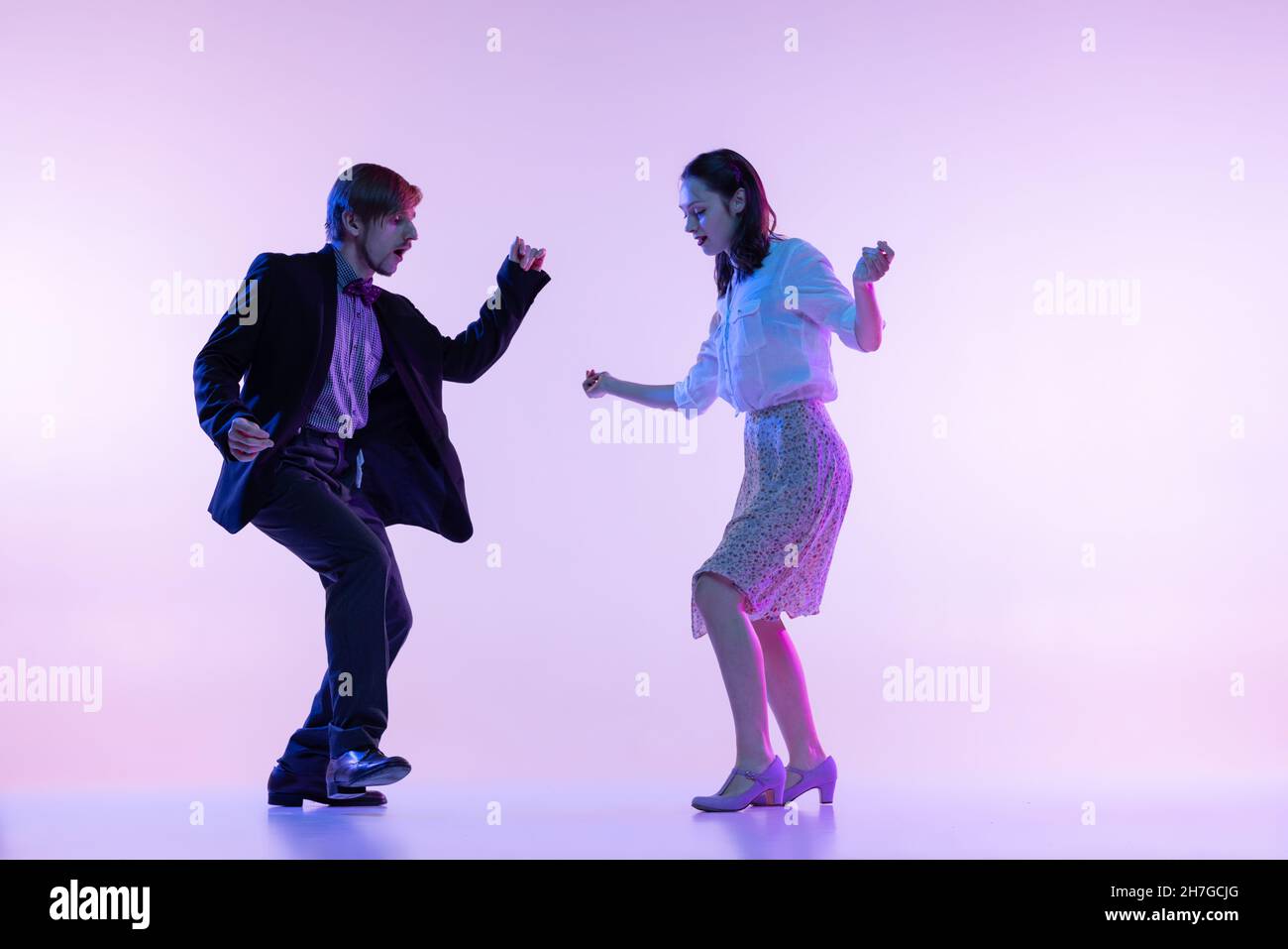 Studio shot of young man and woman in vintage retro style outfits ...