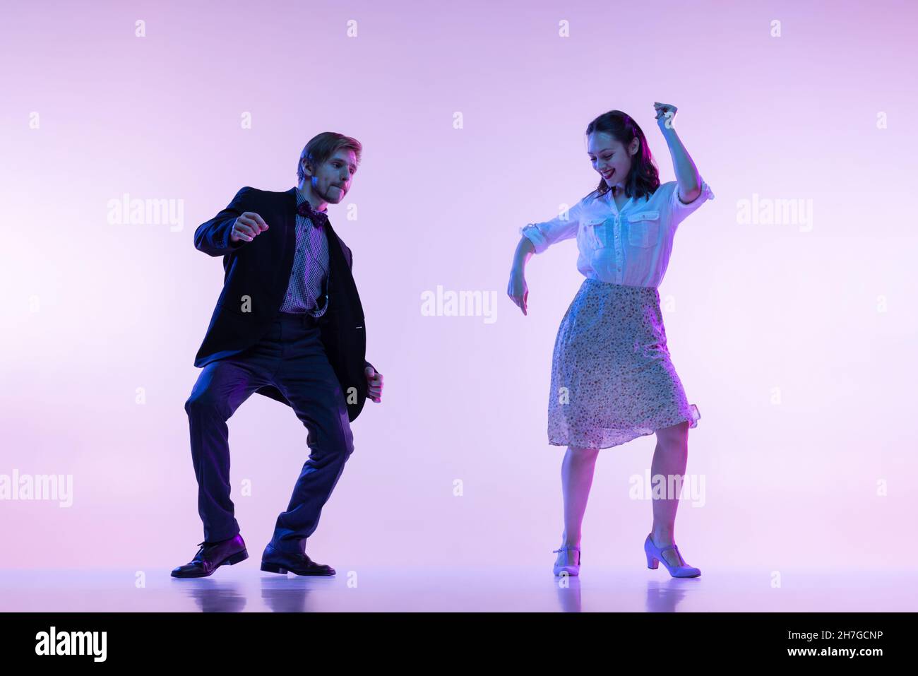 Two young graceful dancers, man and woman in vintage style outfits ...