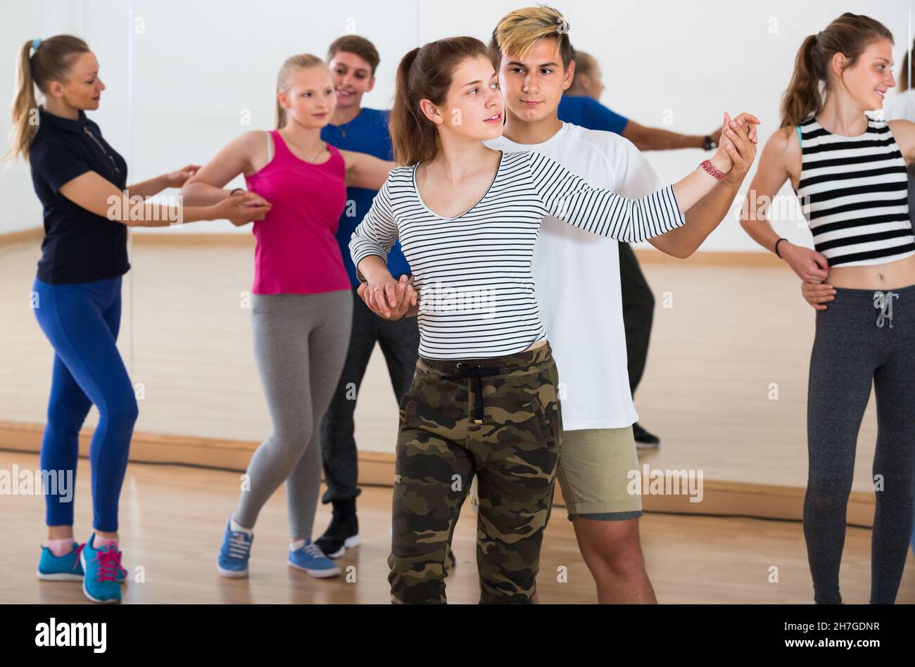 Group of vigorous teen dancing tango in dance studio Stock Photo - Alamy