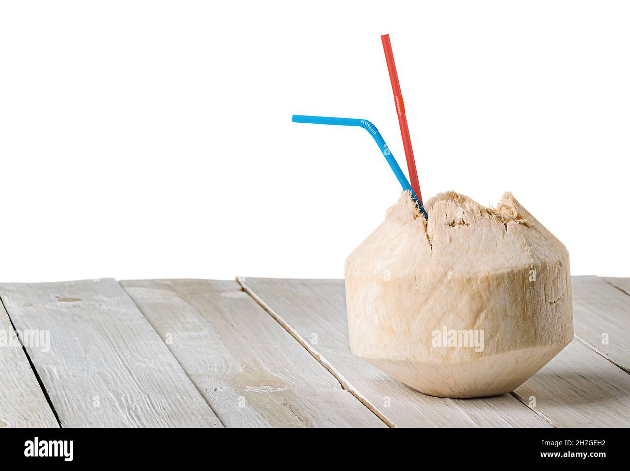 Young coconut on wooden table isolated on white background Stock Photo ...