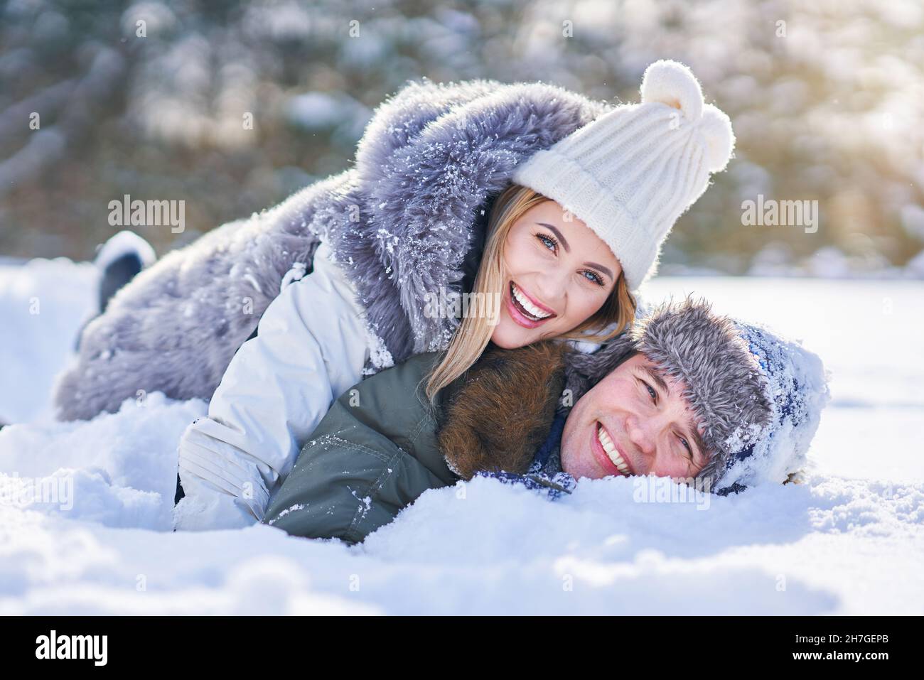 Couple having fun in winter scenery and snow Stock Photo - Alamy