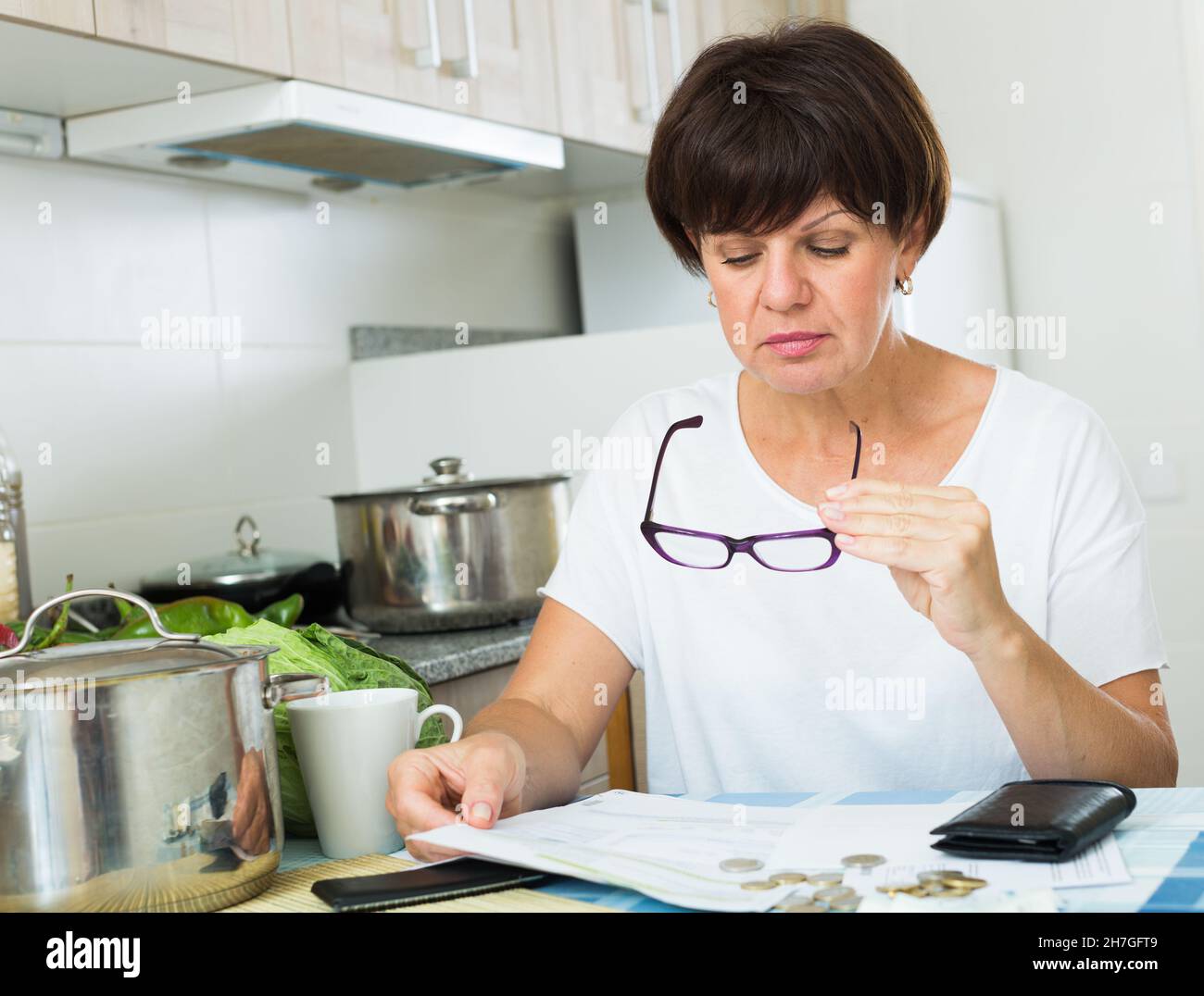 sad woman paying bills Stock Photo - Alamy