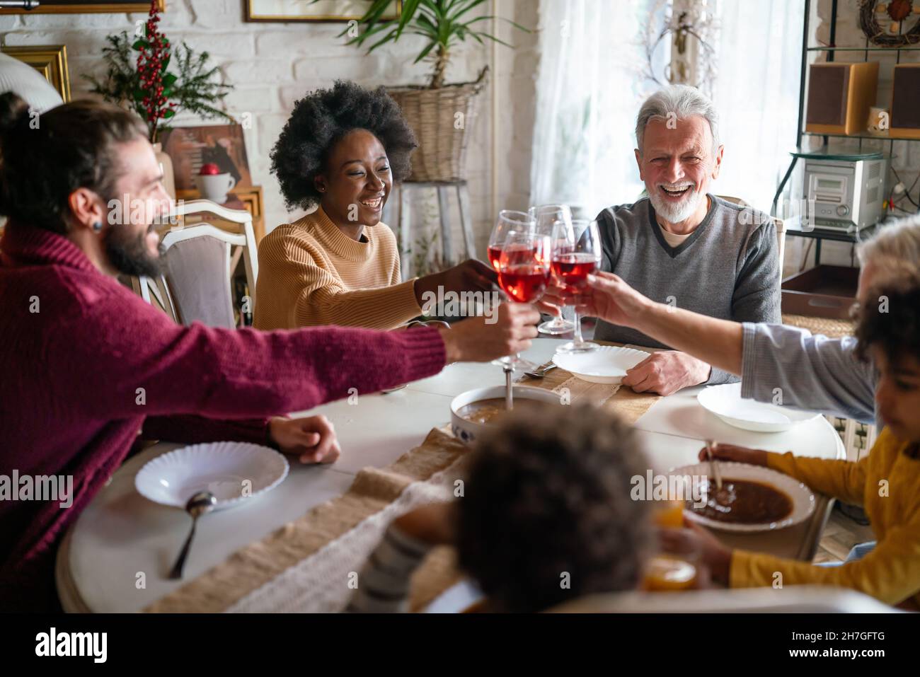 Happy multiethnic multigeneration family having fun together around ...