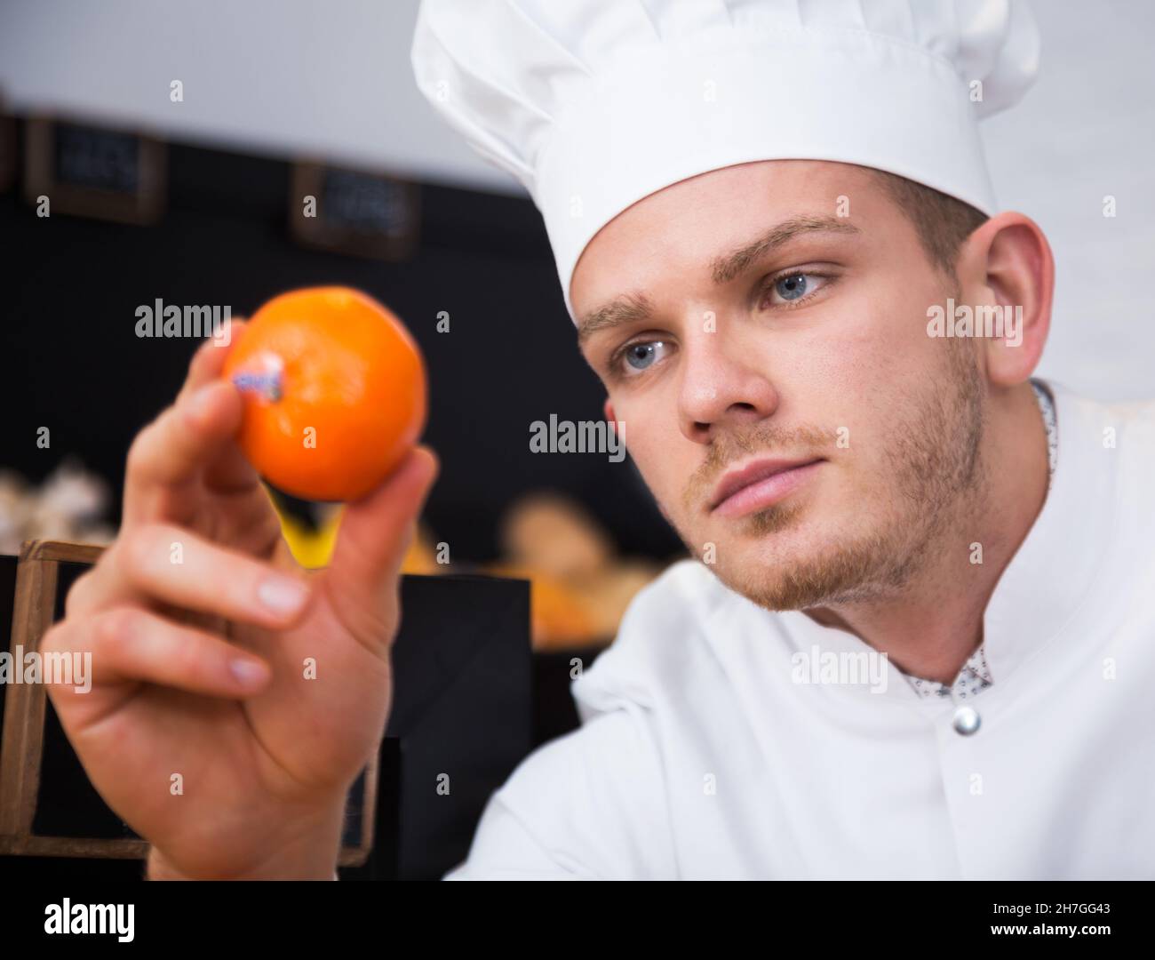 Male cook in grocery shop Stock Photo - Alamy
