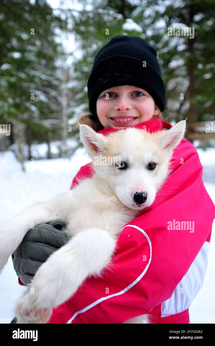 SCANDINAVIA. FINLAND IN WINTER. HOSSA NATIONAL PARK. YOUNG GIRL WITH A ...