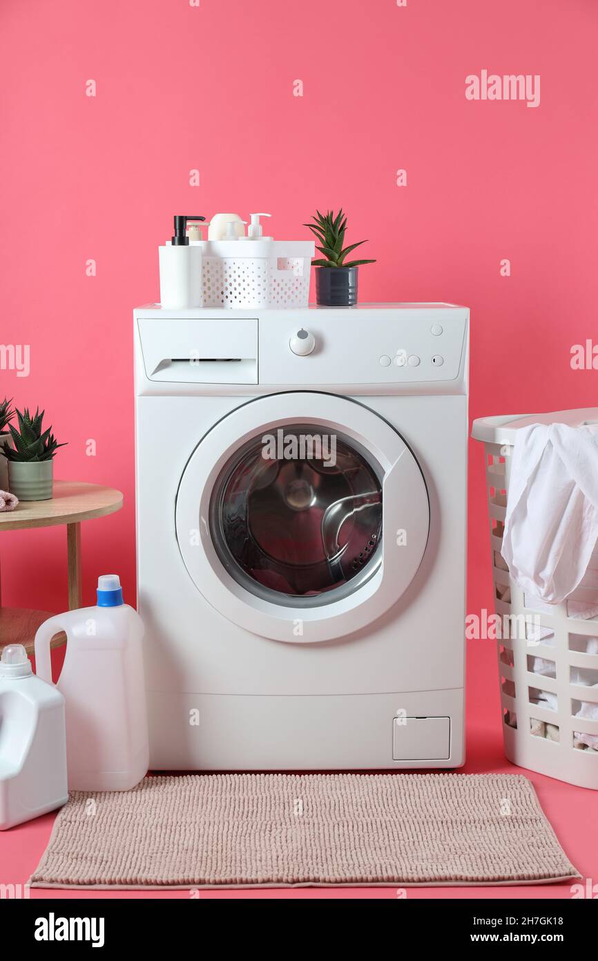Concept of housework with washing machine on pink background Stock ...