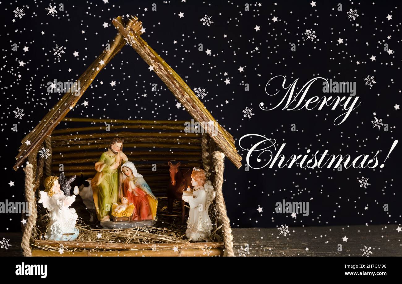 Christmas card with figures of Jesus, Virgin Mary and Joseph on a dark ...