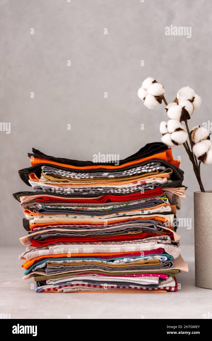 Various natural kitchen napkins stacked close up, cotton branch in ...