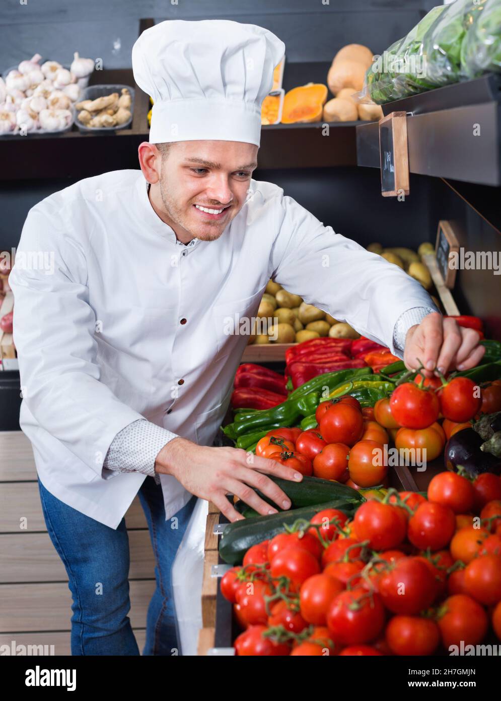 Male cook choosing vegetables in grocery shop Stock Photo - Alamy
