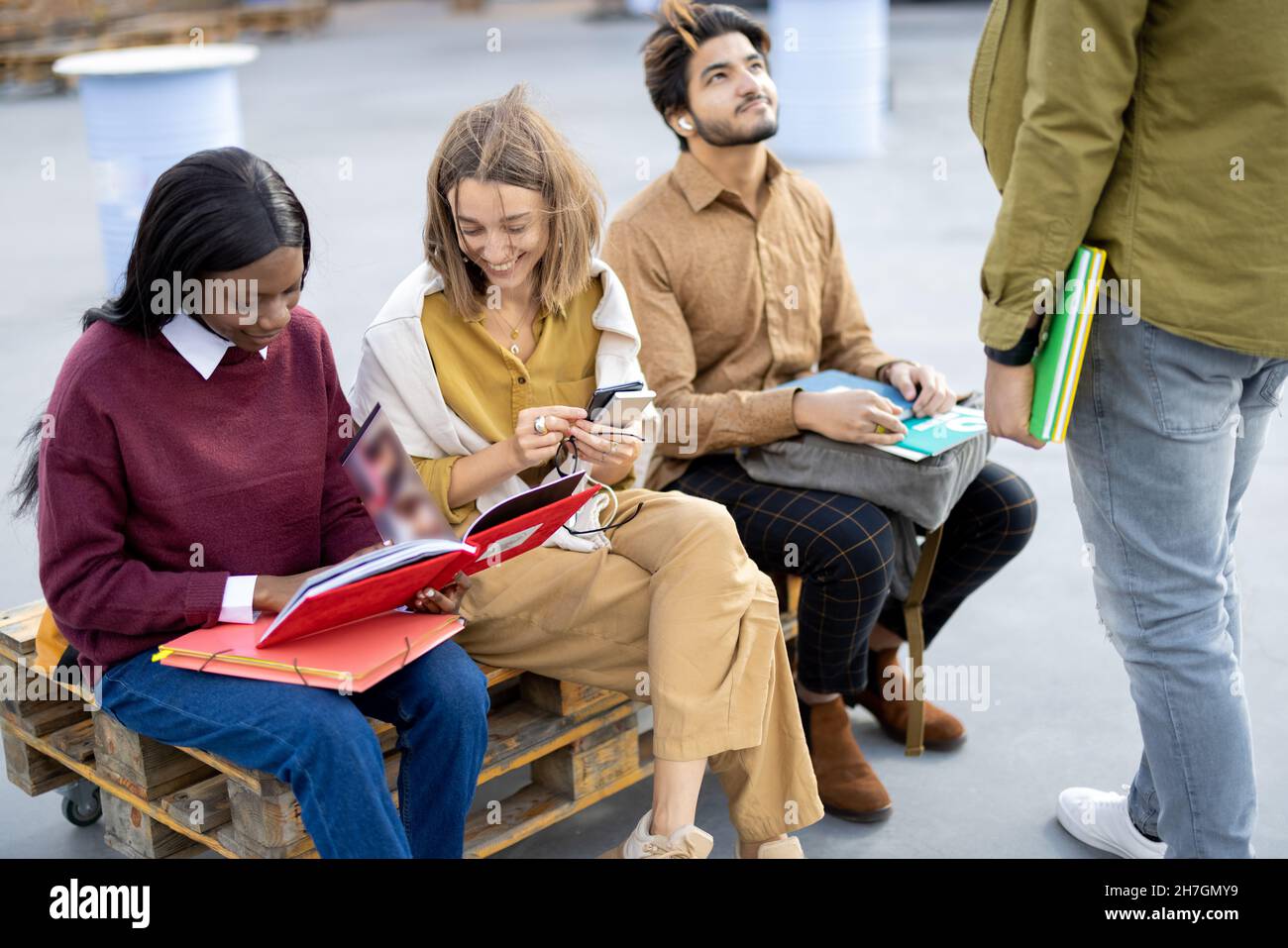 Young students read books at university campus Stock Photo - Alamy