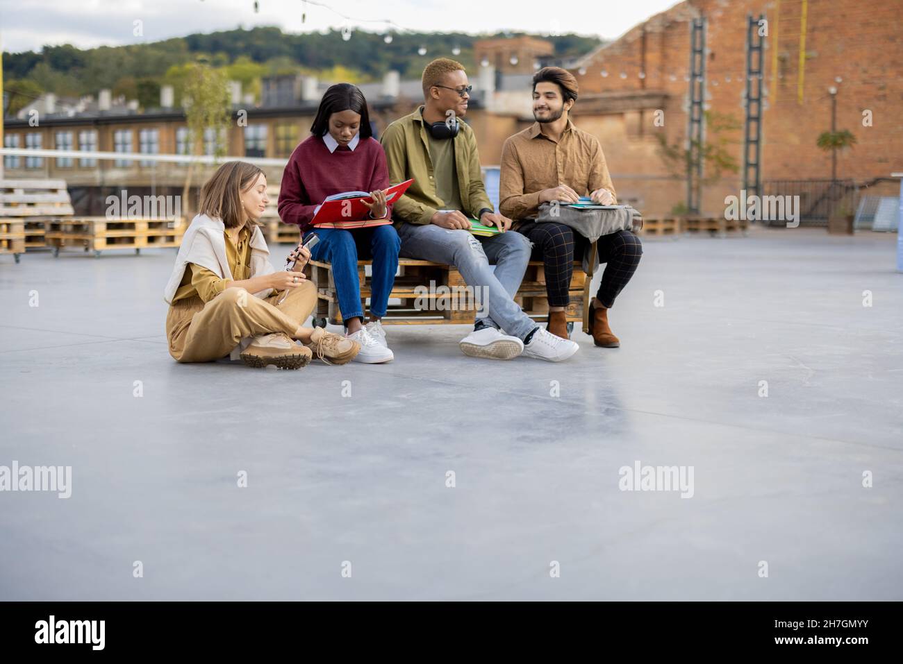 Young students read books at university campus Stock Photo - Alamy