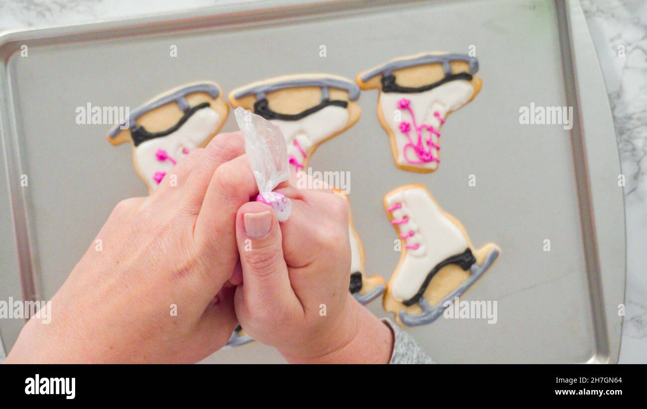 Flat lay. Icing figure skate shaped sugar cookies with royal icing ...