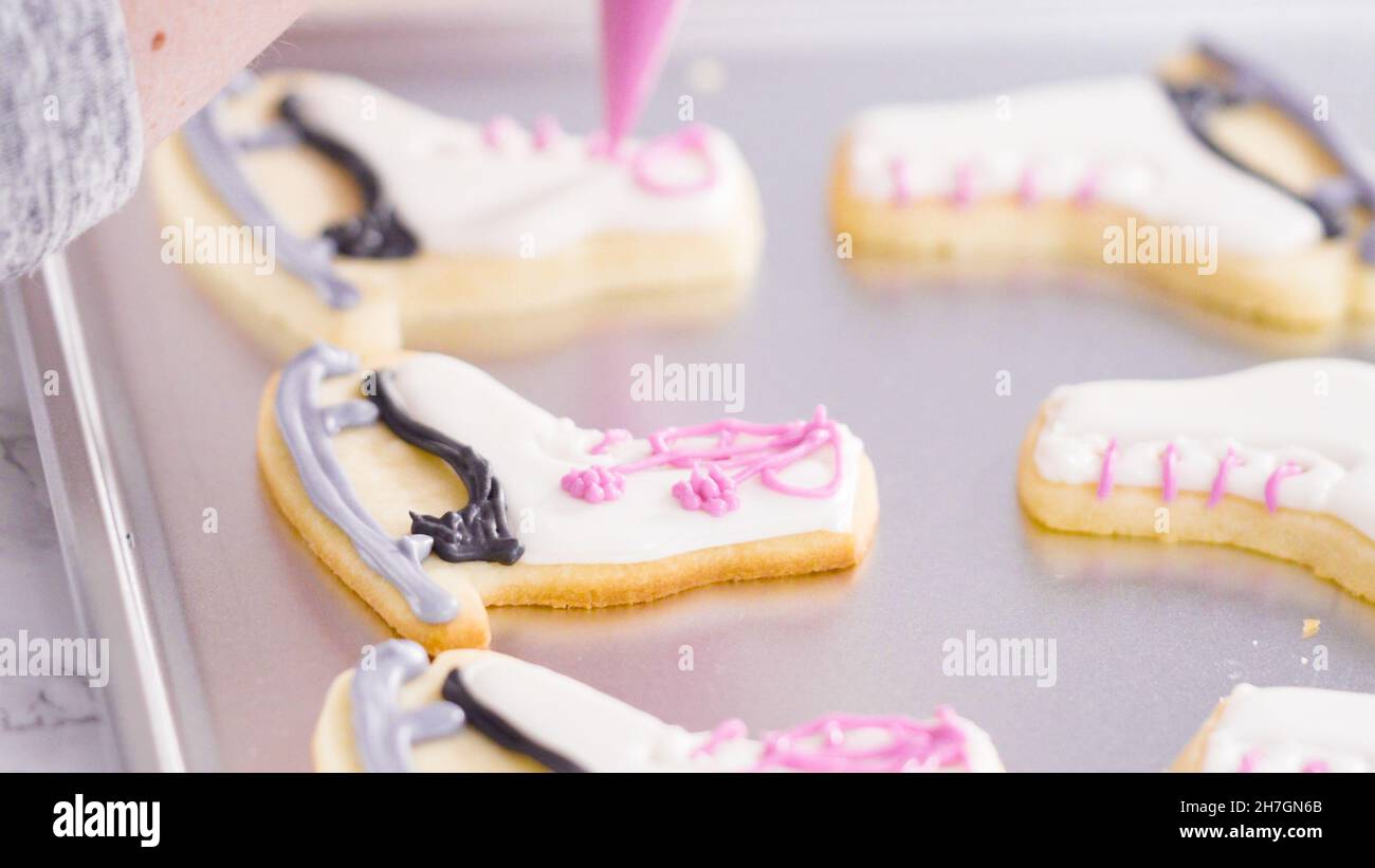 Icing figure skate shaped sugar cookies with royal icing Stock Photo ...
