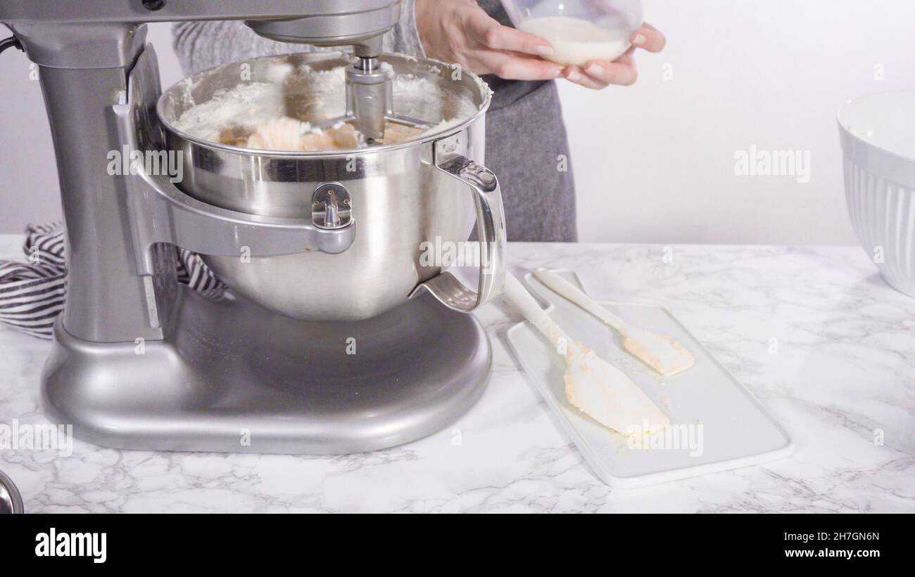 Step by step. Mixing ingredients in standing kitchen mixer to bake ...