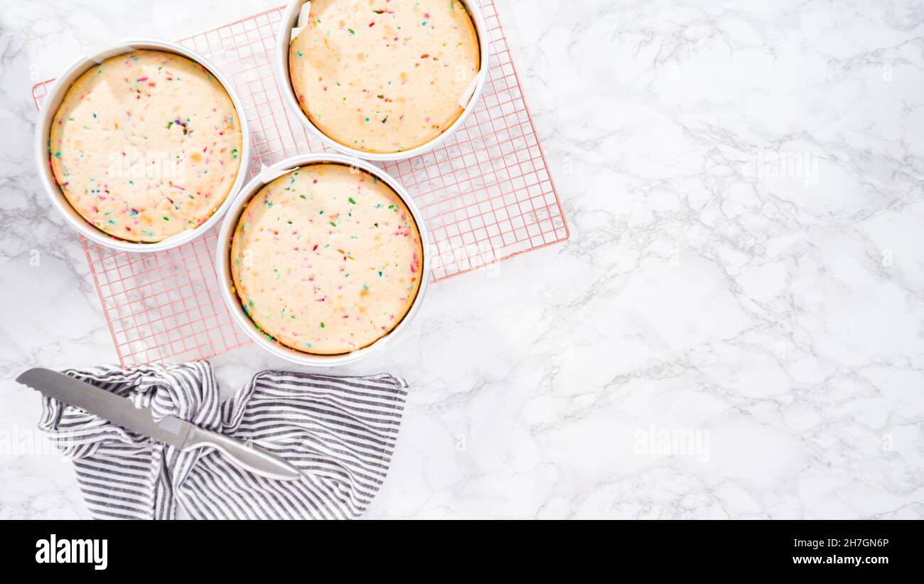 Flat lay. Step by step. Cooling freshly baked funfetti cake layers on a ...