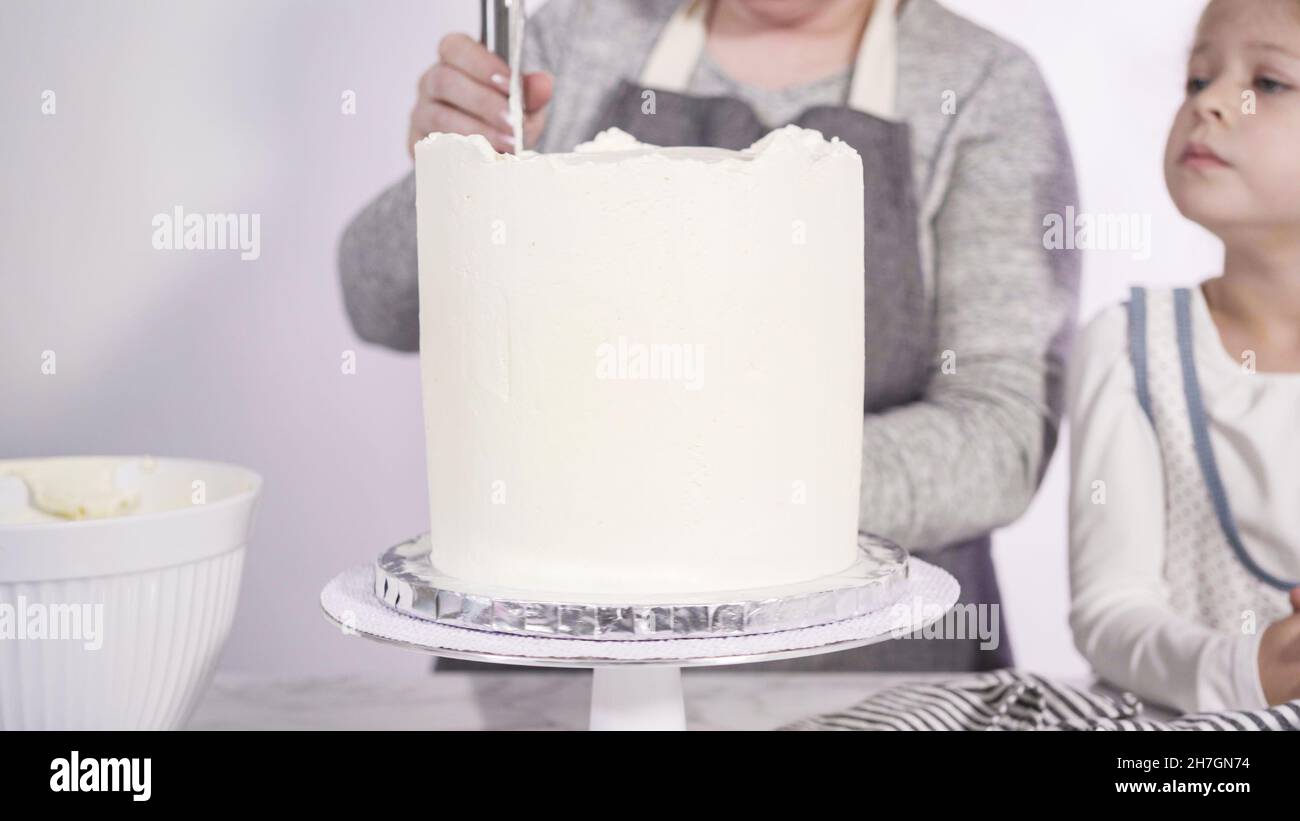 Step by step. Frosting round funfetti cake with white italian ...