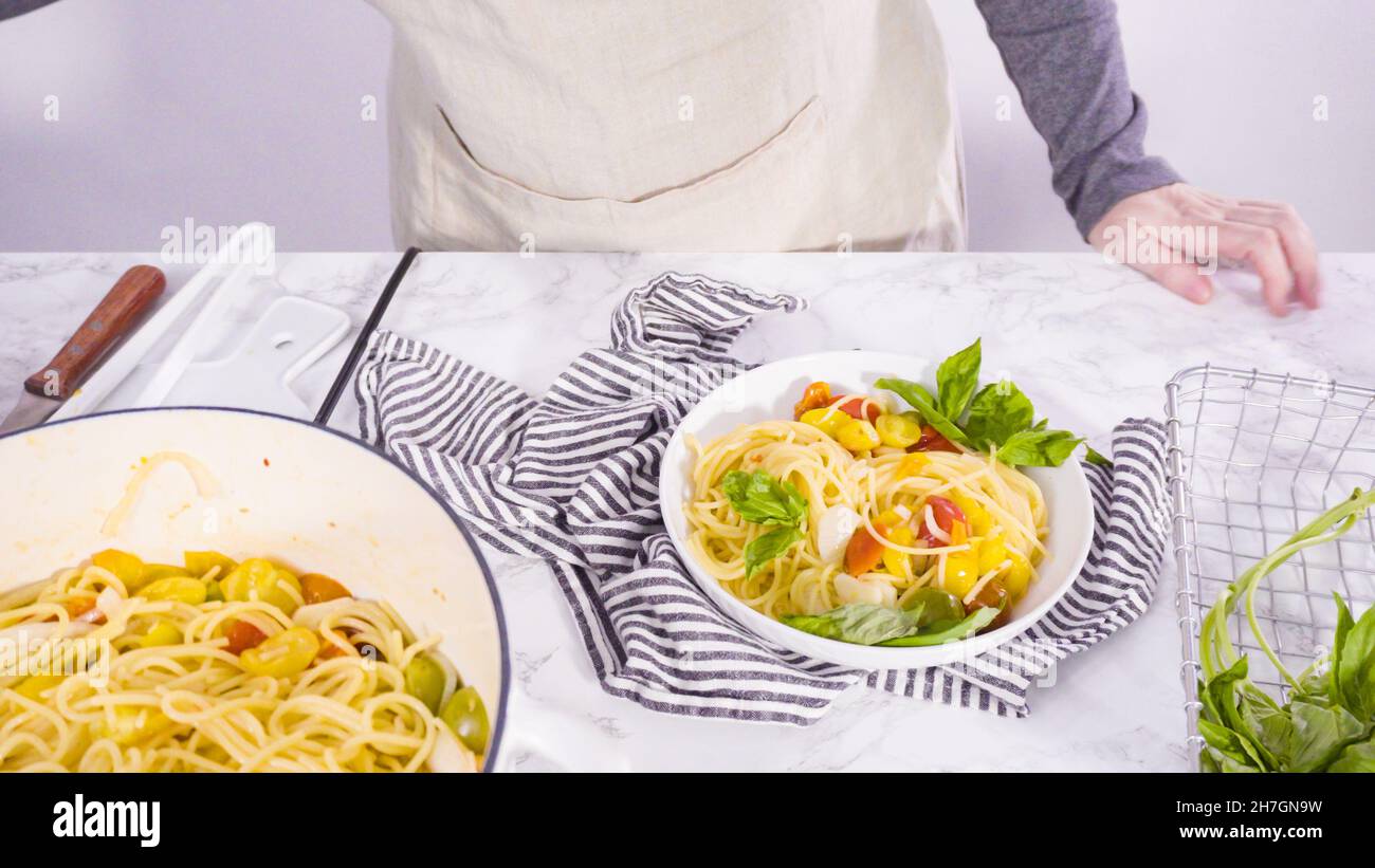 Step by step. Serving a one-pot pasta into a white pasta plate Stock ...