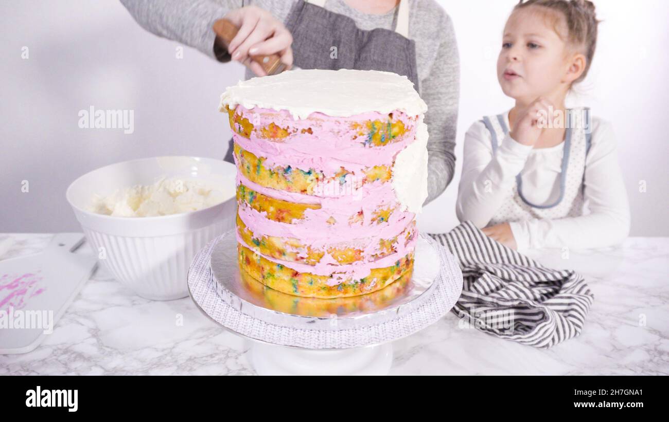 Step by step. Frosting round funfetti cake with white italian ...