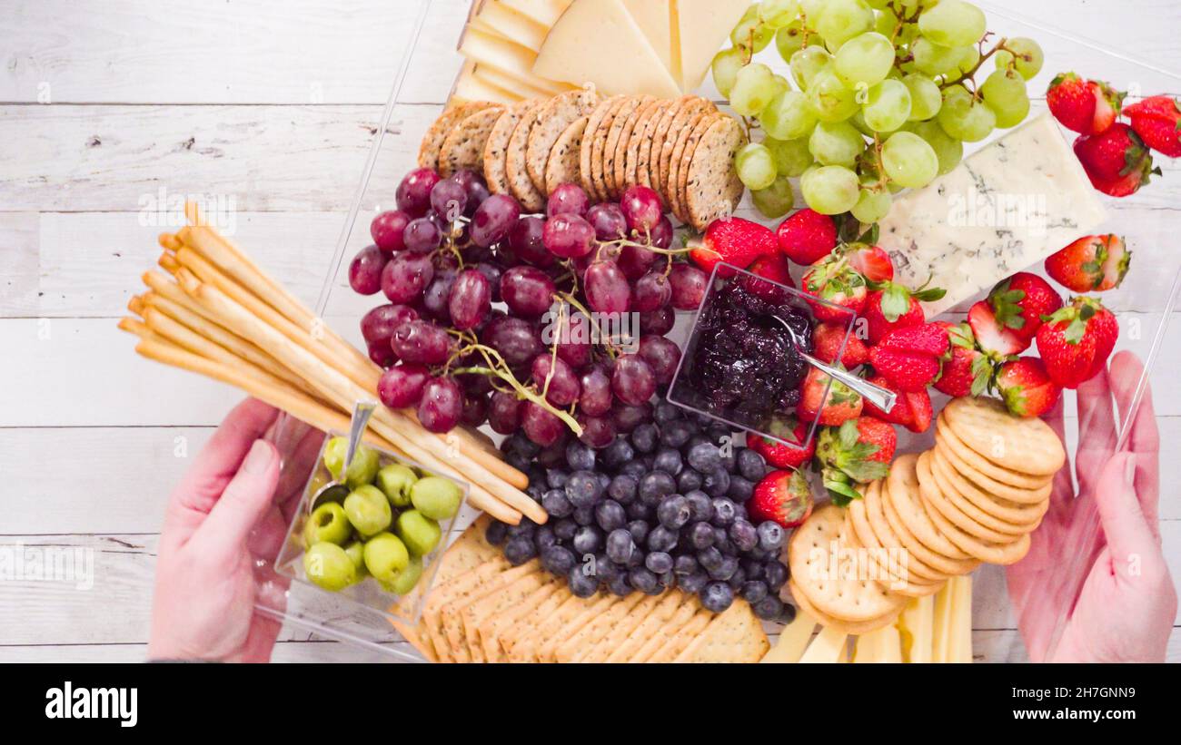 Flat lay. Step by step. Arranging cheese platter with fresh fruits ...